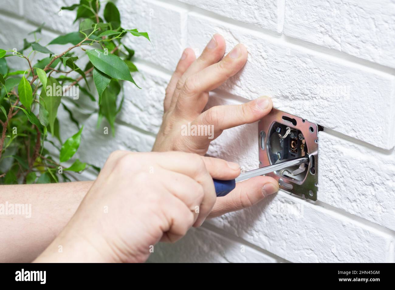 Electrician working safely on switches and sockets of a residential ...