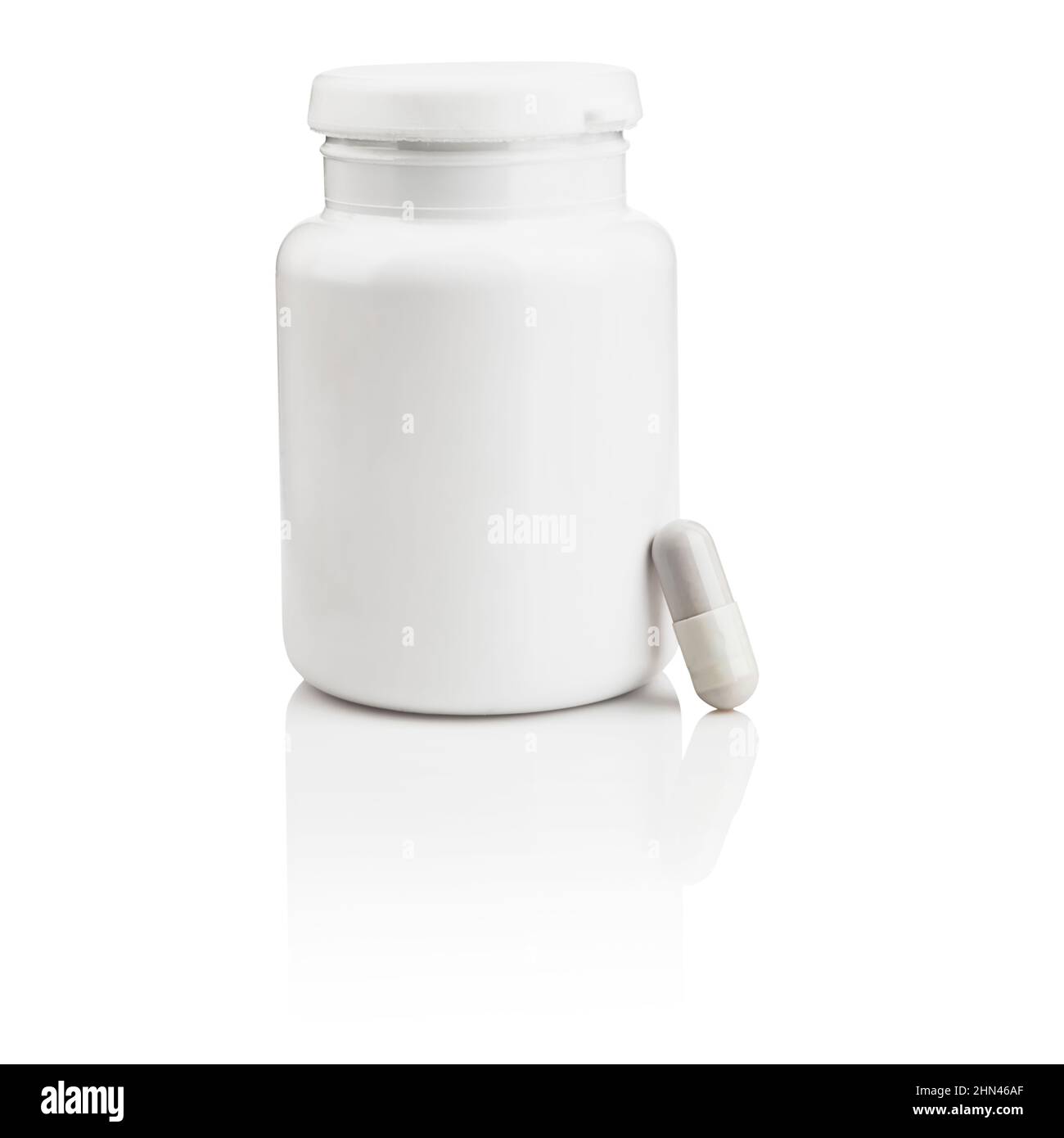 Plastic pills bottle and a capsule isolated on white background with ...