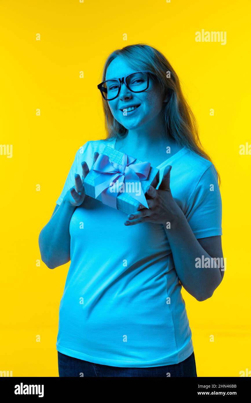 Beautiful young girl with freckles on her face isolated on yellow ...