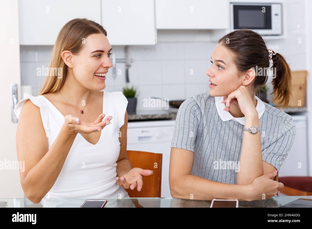 Two girls having emotional conversation Stock Photo - Alamy