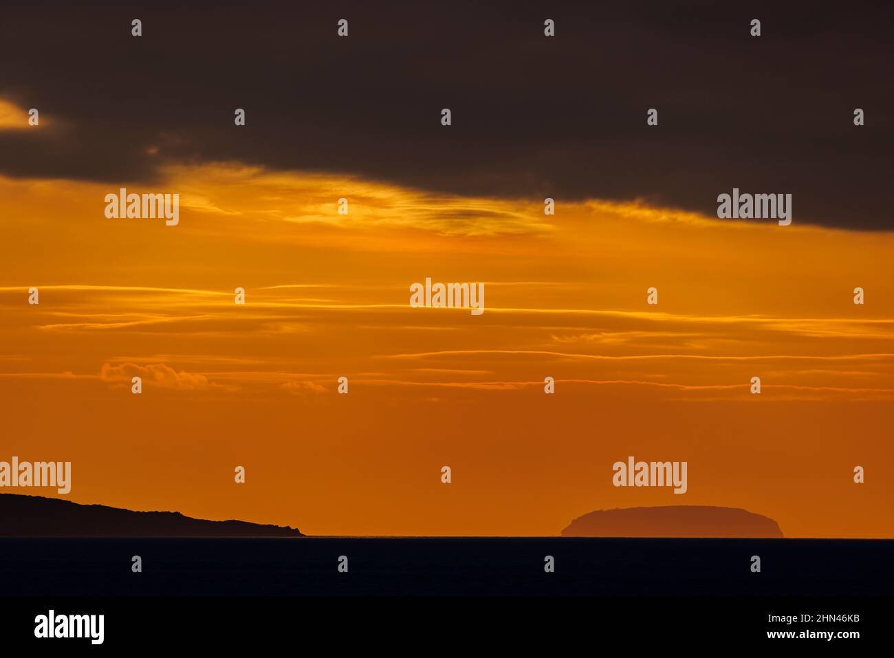 The setting sun lighting up the horizon Stock Photo - Alamy