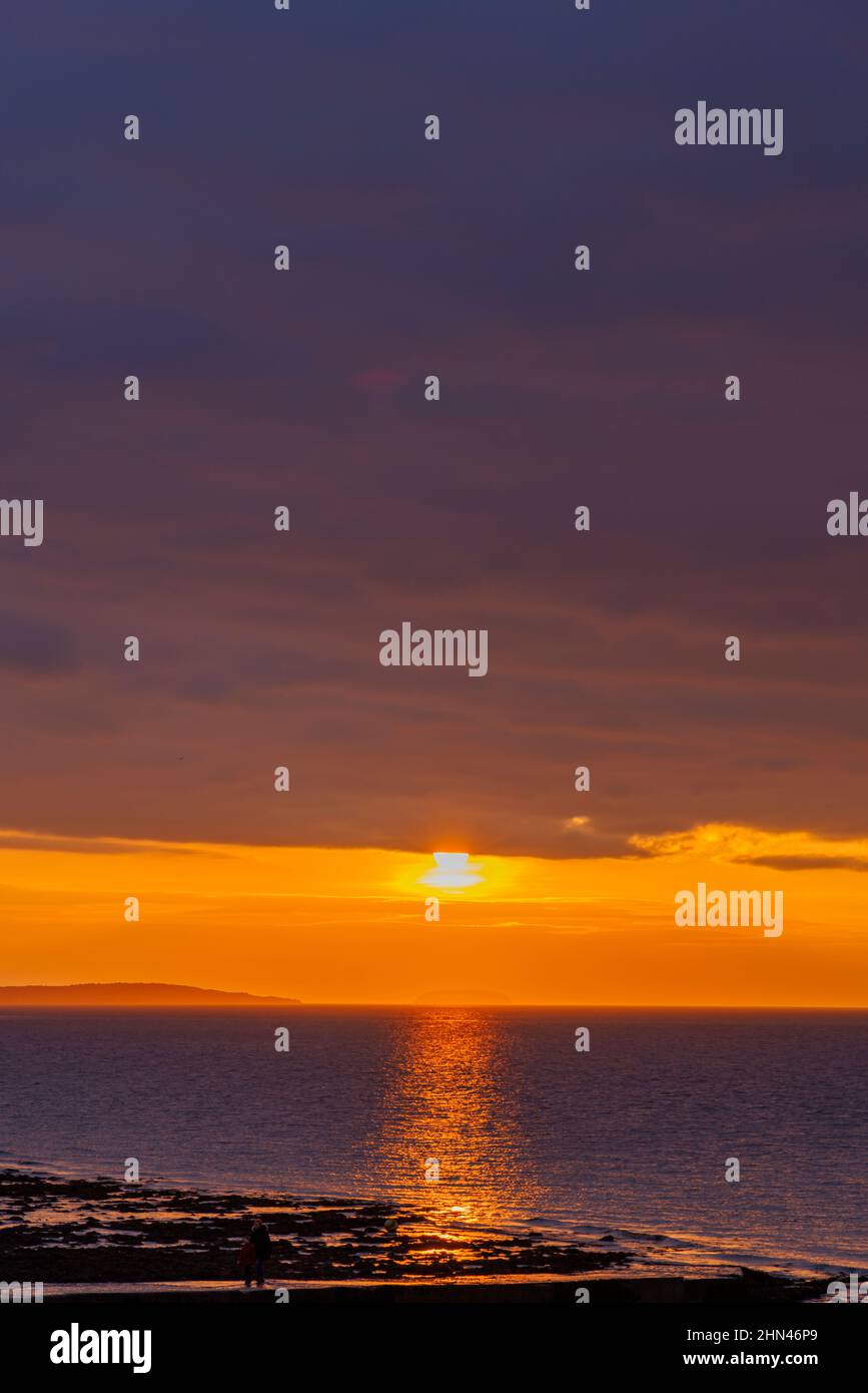 The setting sun lighting up the horizon Stock Photo - Alamy