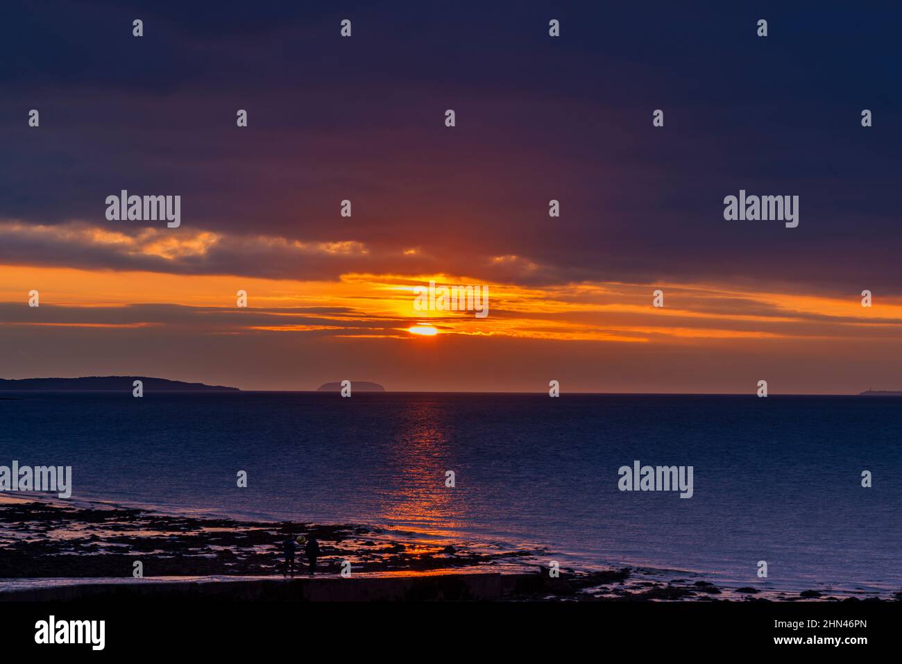 The setting sun lighting up the horizon Stock Photo - Alamy