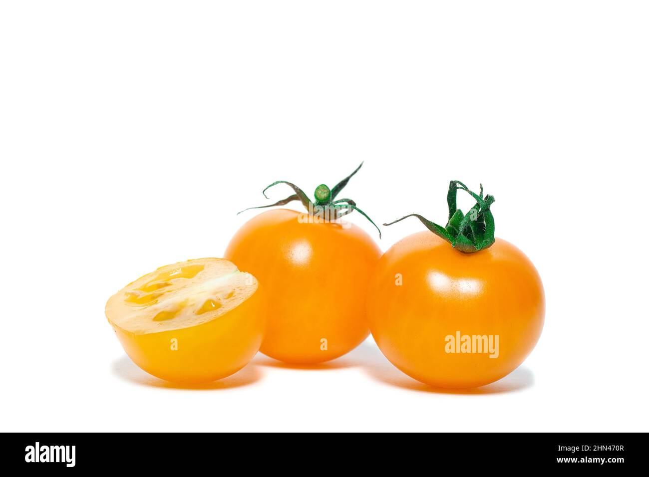 fresh yellow "tasty tom" tomatoes on the vine on a white background ...