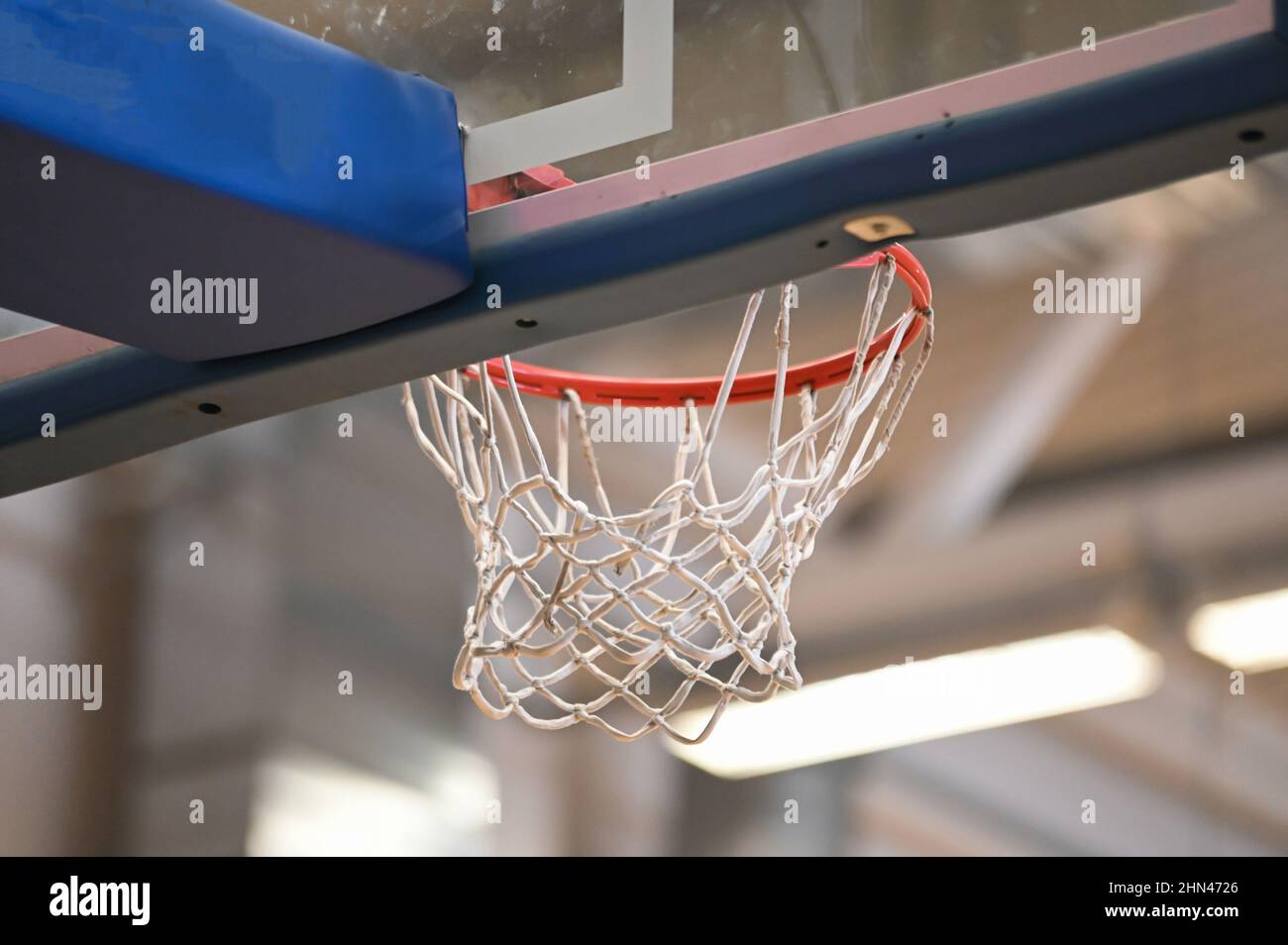 Basketball hoop close up in old school sport gym hall Stock Photo - Alamy