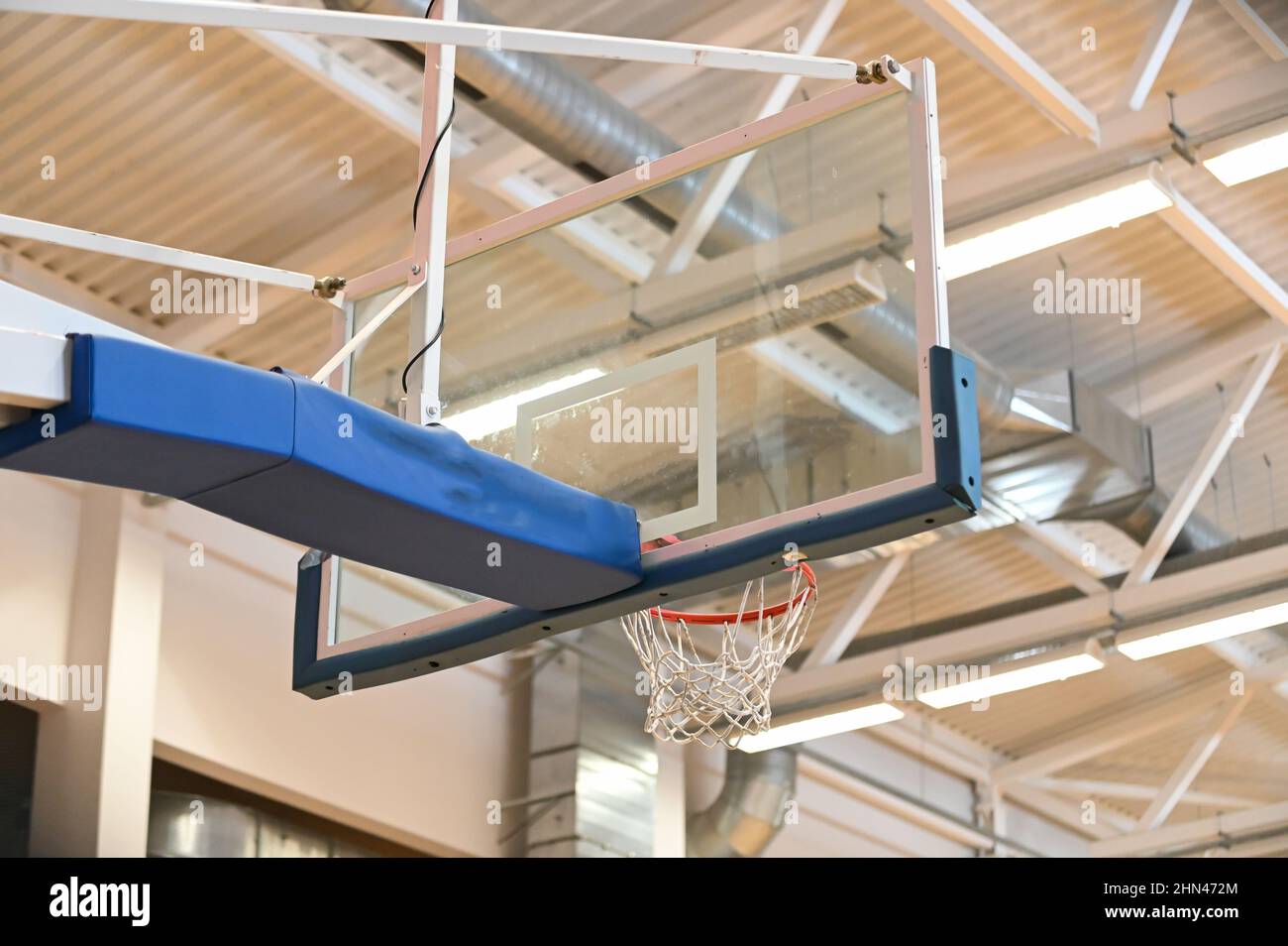 Basketball hoop close up in old school sport gym hall Stock Photo - Alamy