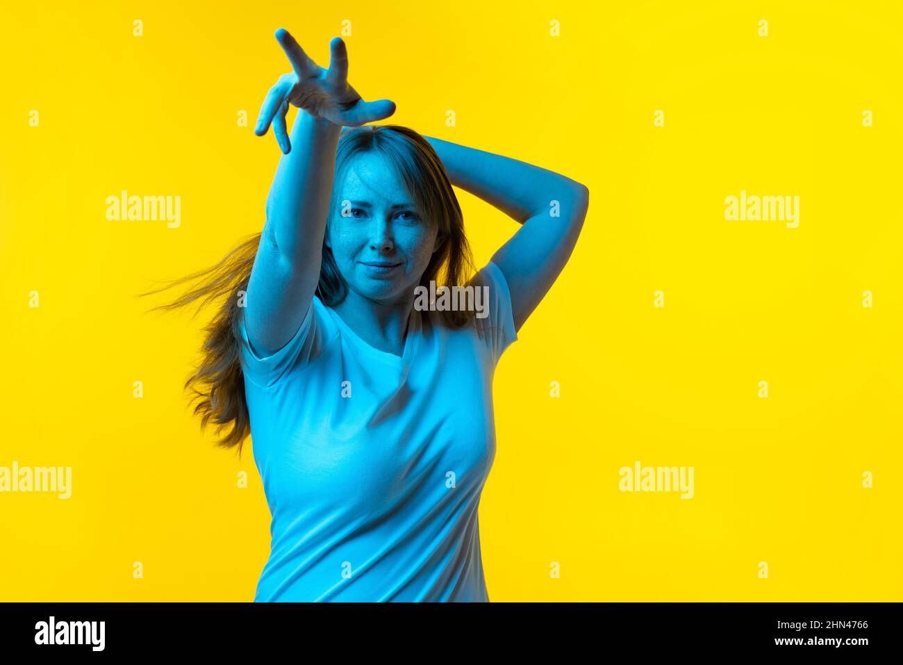 Beautiful young girl with freckles on her face dancing isolated on ...