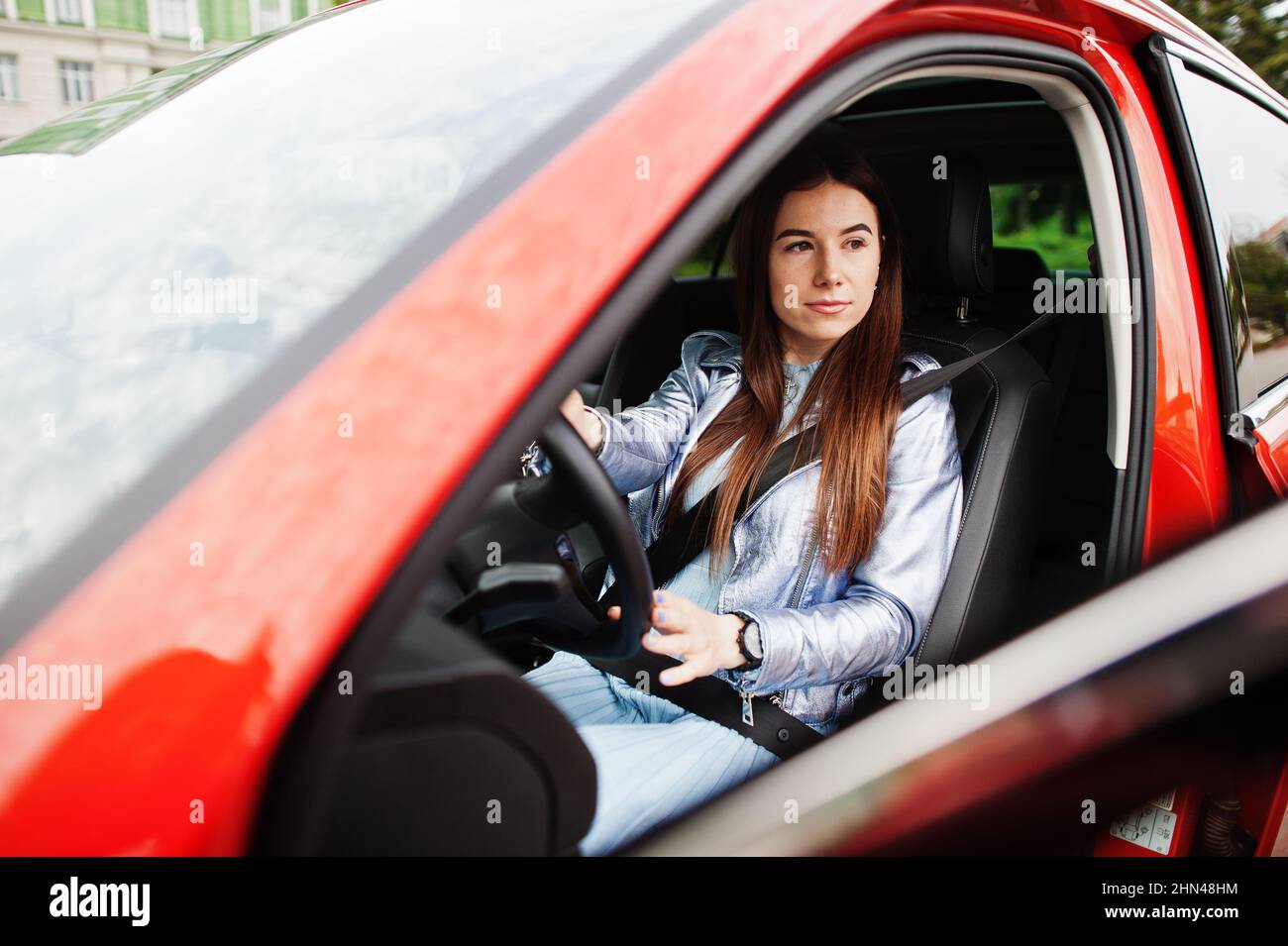 Gorgeous woman sitting inside car with open door Stock Photo - Alamy