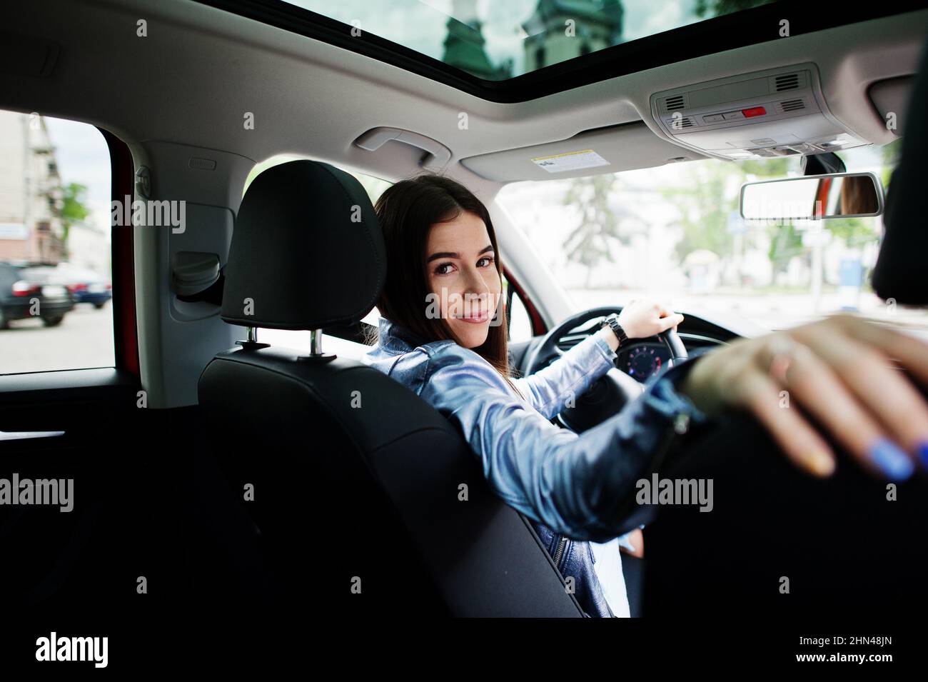 Gorgeous woman sitting inside car interior Stock Photo - Alamy