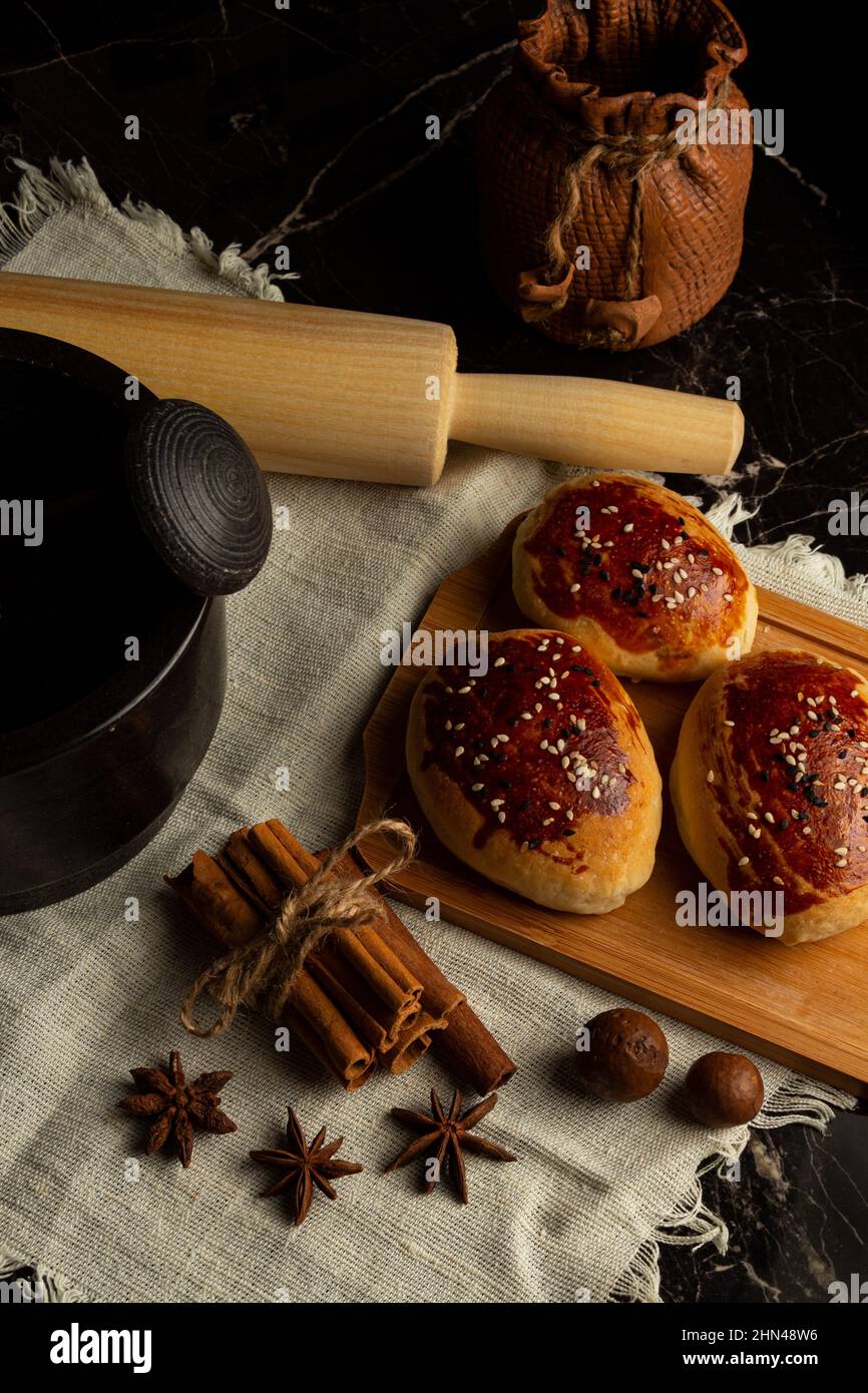 Fresh pies are ready to eat and lie surrounded by kitchen utensils ...