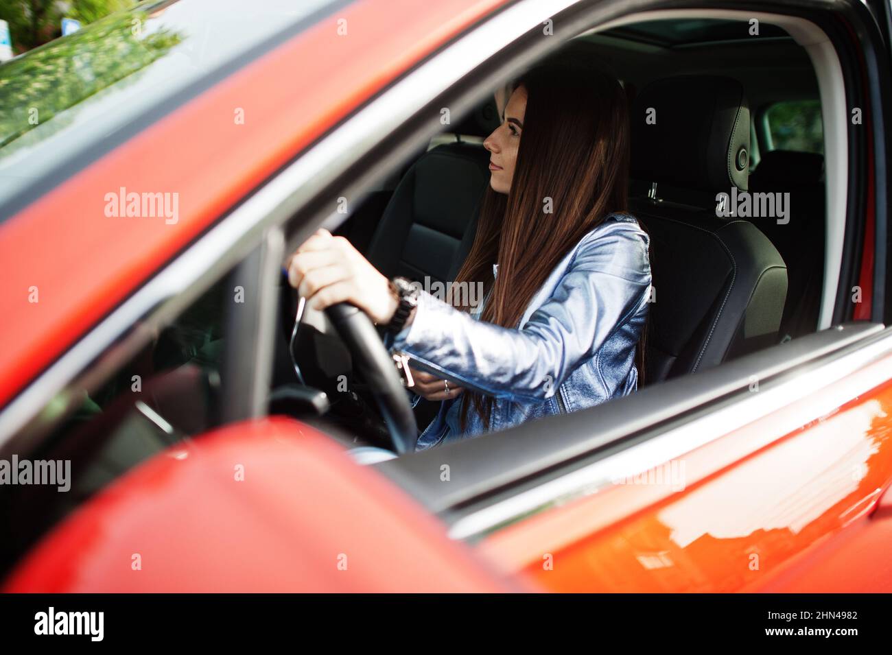 Gorgeous woman sitting inside car interior Stock Photo - Alamy