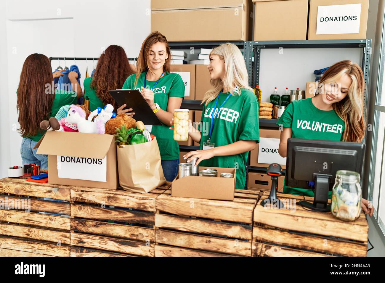 Group of young volunteers woman smiling happy working at charity center ...