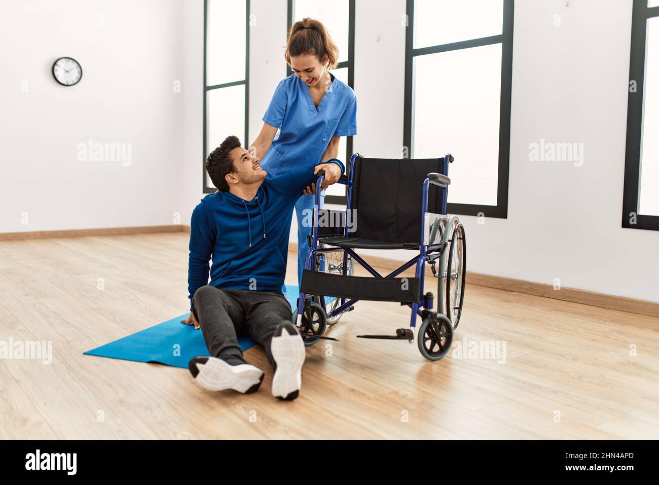 Young disabled man making mobility exercise at the clinic Stock Photo ...