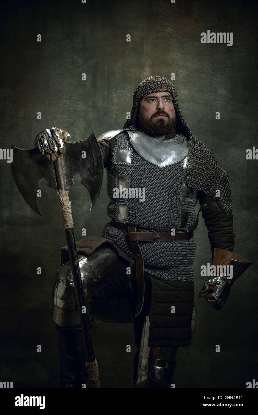 Vintage portrait of brutal seriuos man, medieval warrior or knight with ...