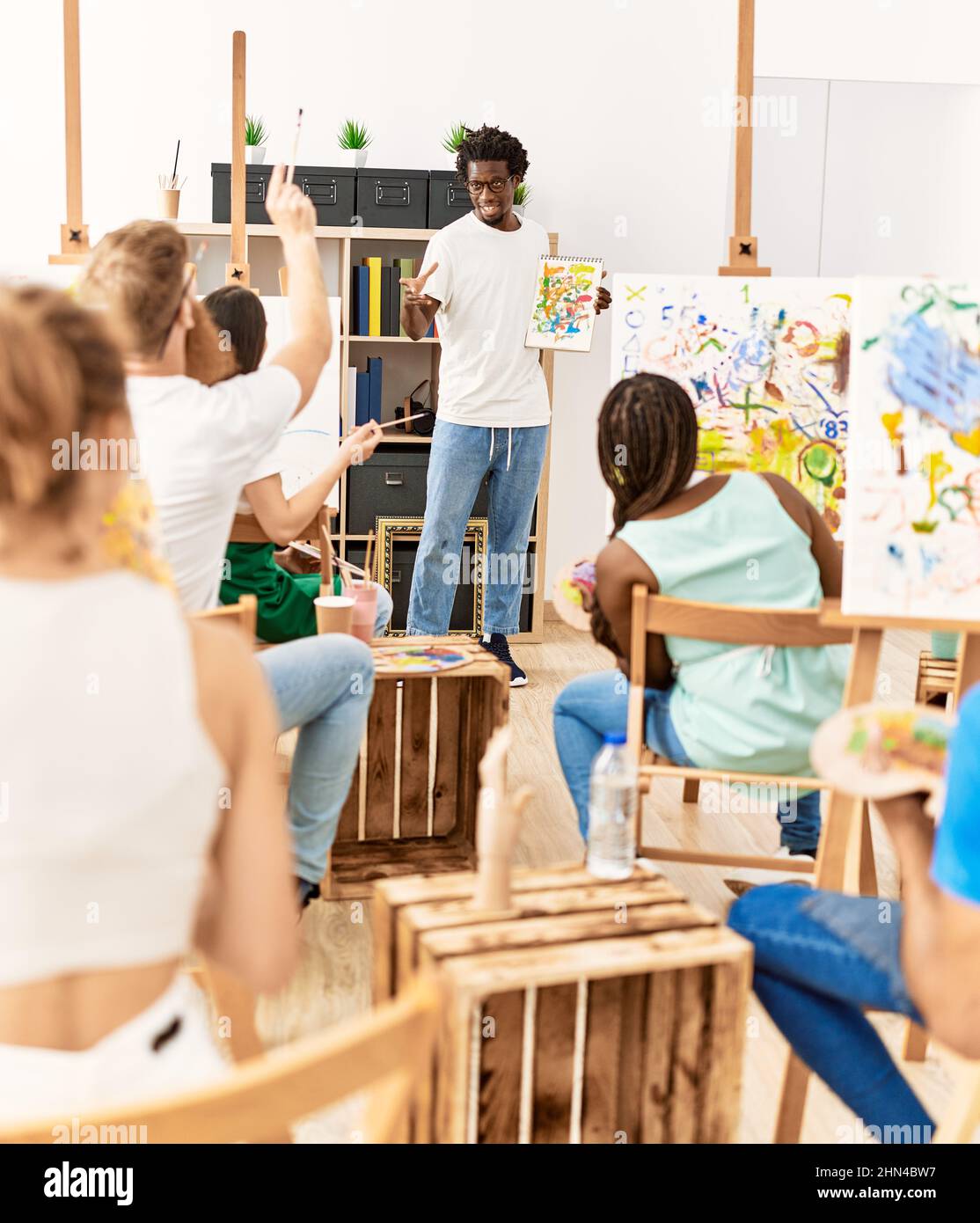 Group of people smiling happy drawing in paint class at art studio ...