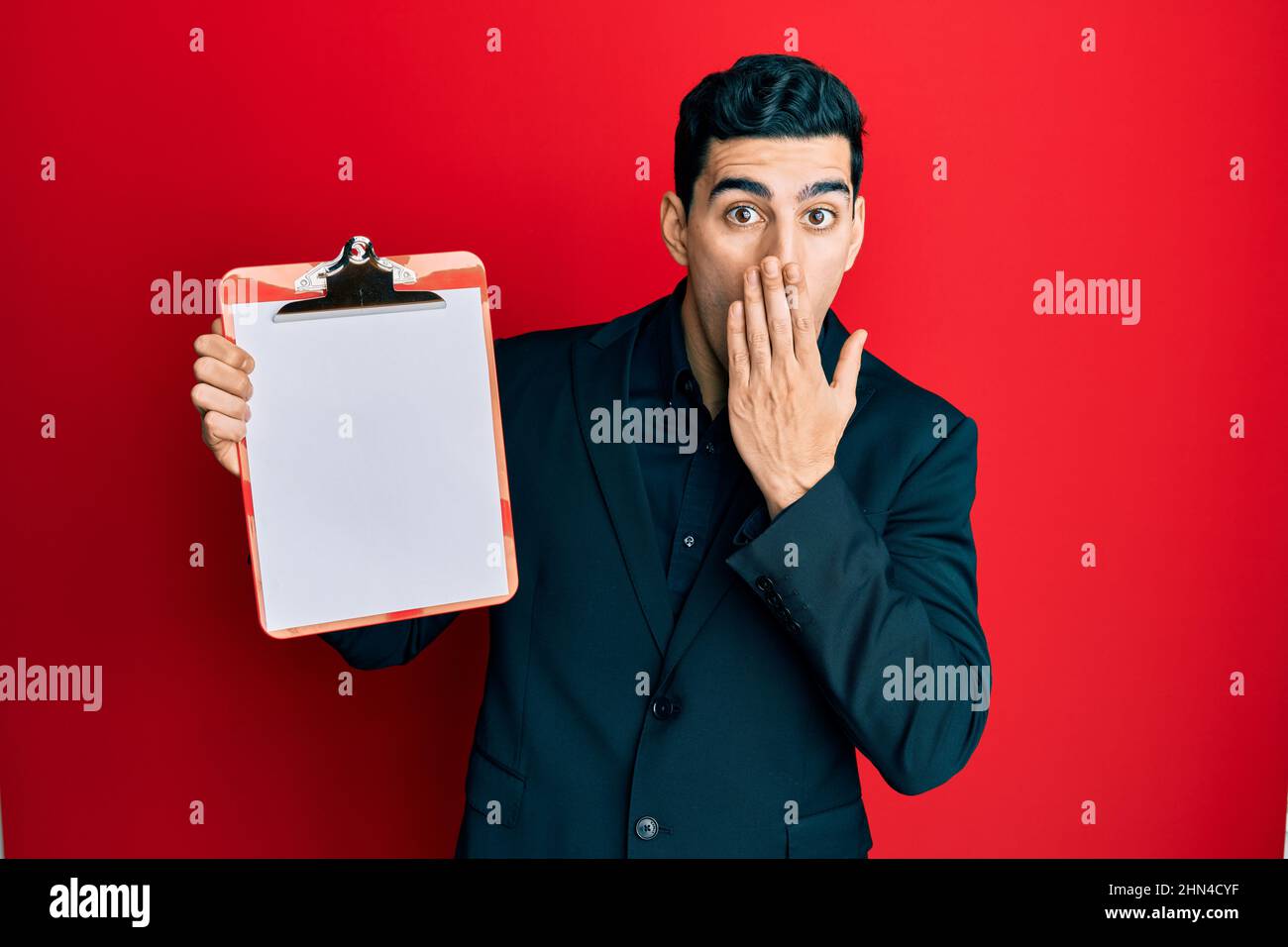 Handsome hispanic business man holding clipboard with blank space ... Handsome hispanic business man holding clipboard with blank space ...