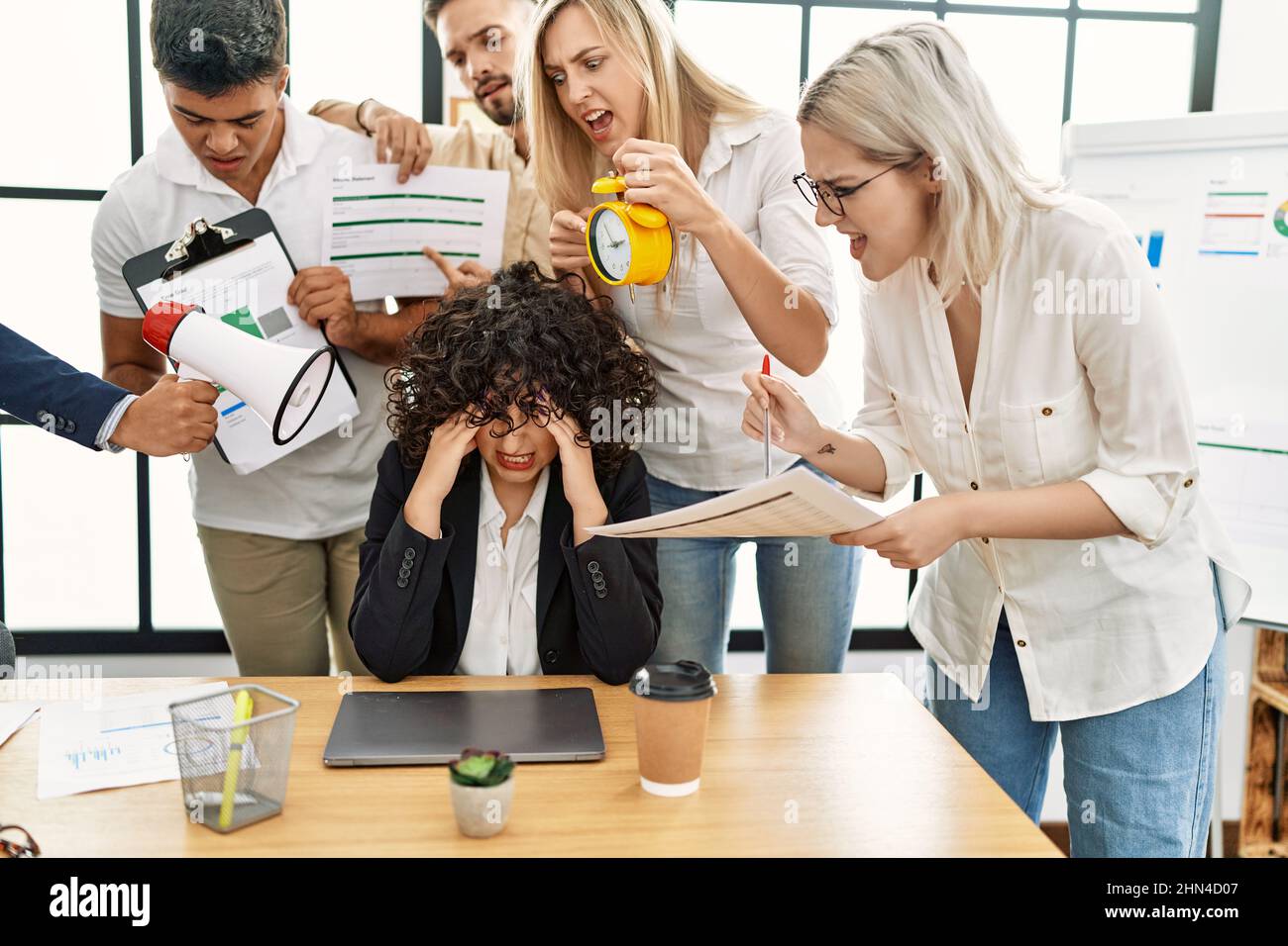 Group of business workers screaming to stressed partner at the office ...