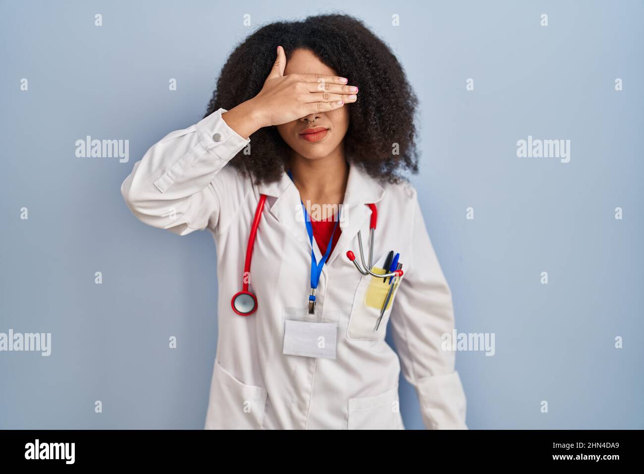 Young african american woman wearing doctor uniform and stethoscope ...