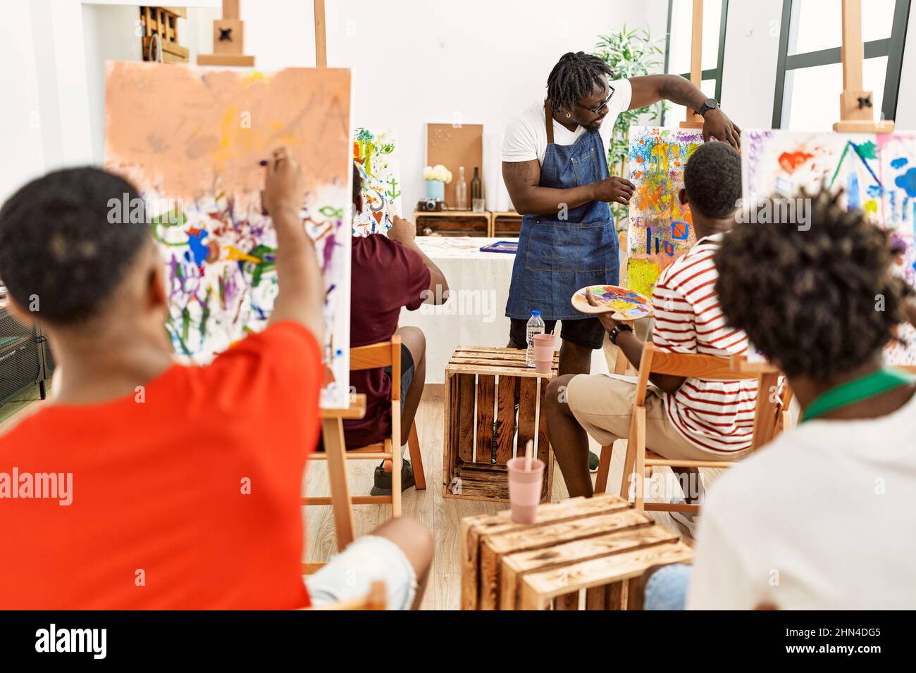 Group of young african american artist students drawing in paint class ...