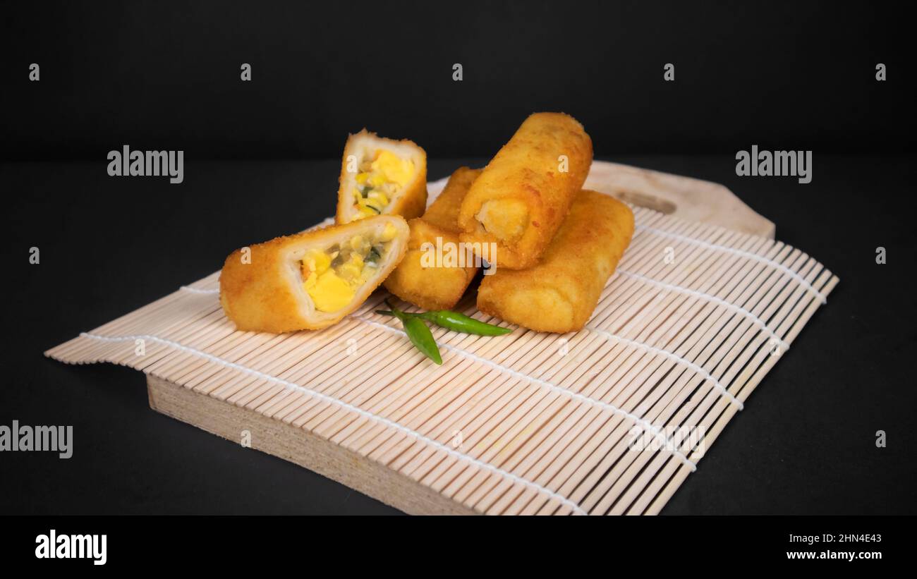 sliced Indonesian Rissoles on a black background Stock Photo - Alamy