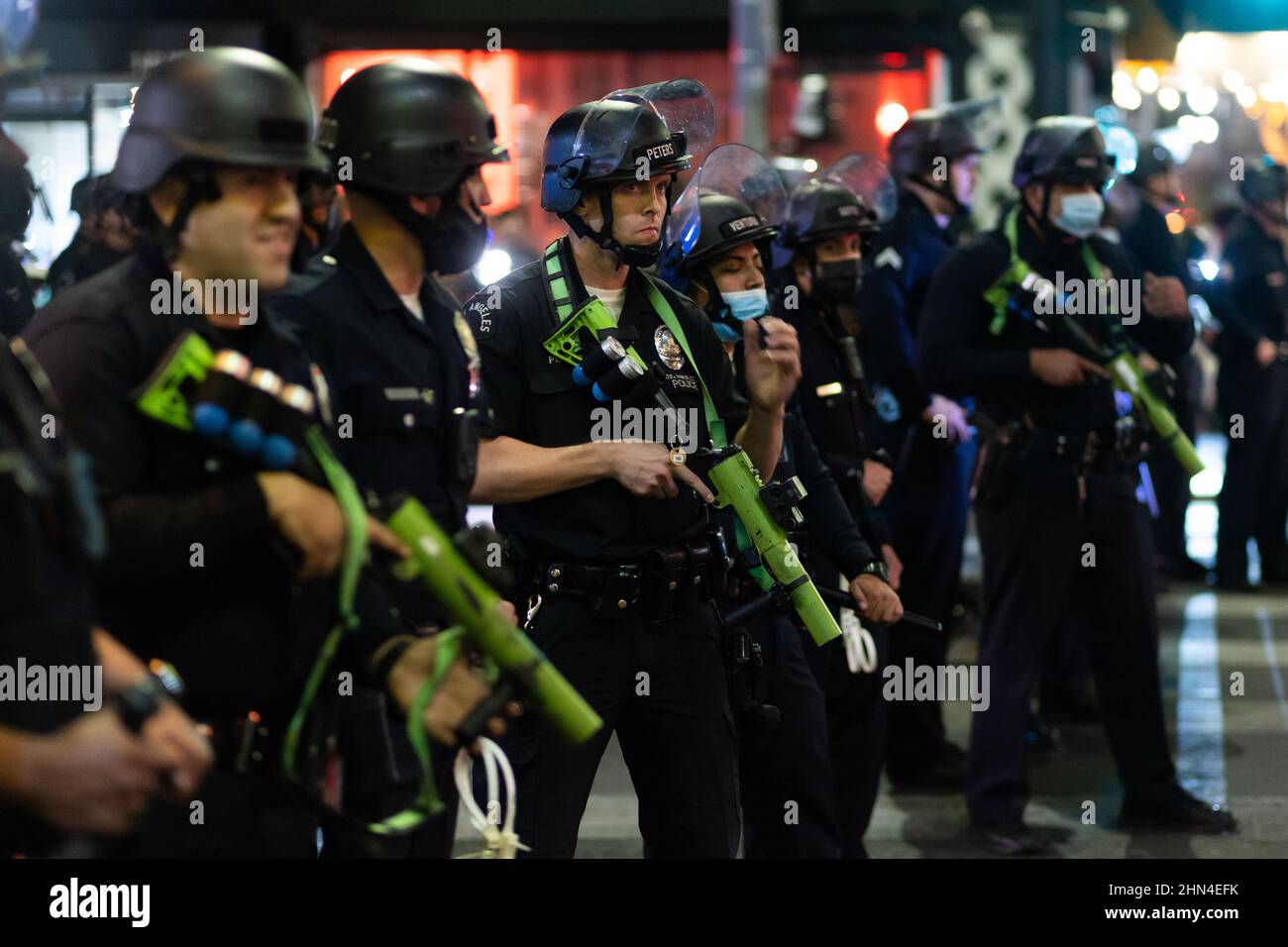 Los Angeles Police officers in riot gear hold 40mm less-lethal ...