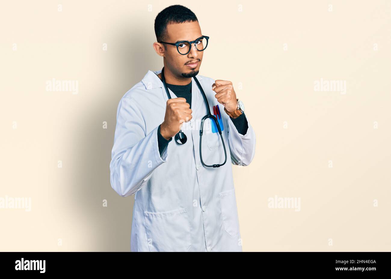 Young african american man wearing doctor uniform and stethoscope ready ...
