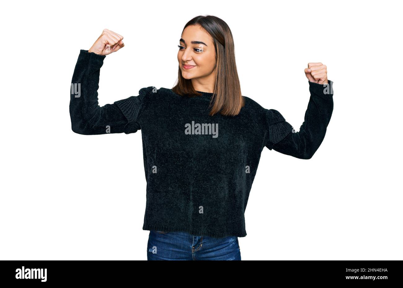 Beautiful brunette woman wearing elegant sweater showing arms muscles ...