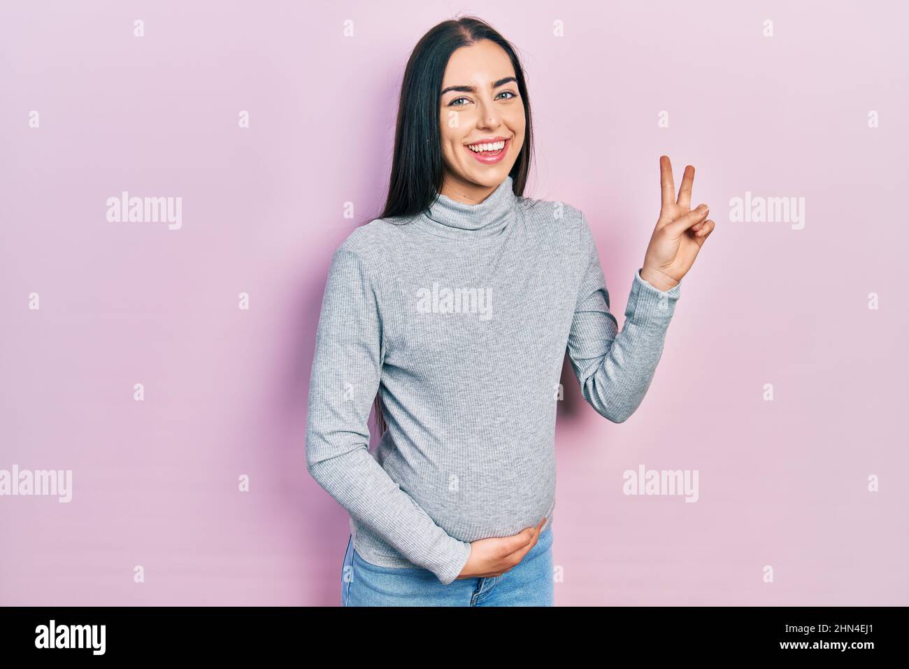 Beautiful woman with blue eyes expecting a baby, touching pregnant ...