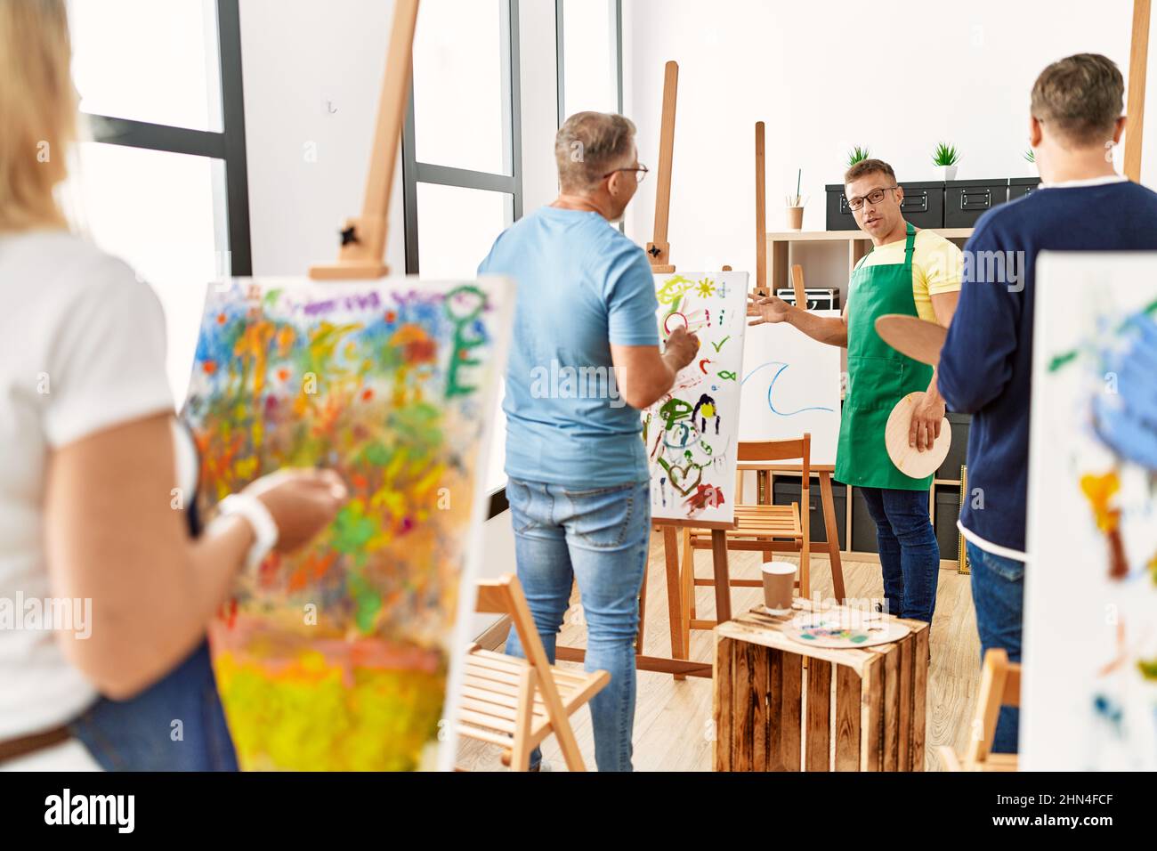 Group of middle age paint students having art class at drawing studio ...