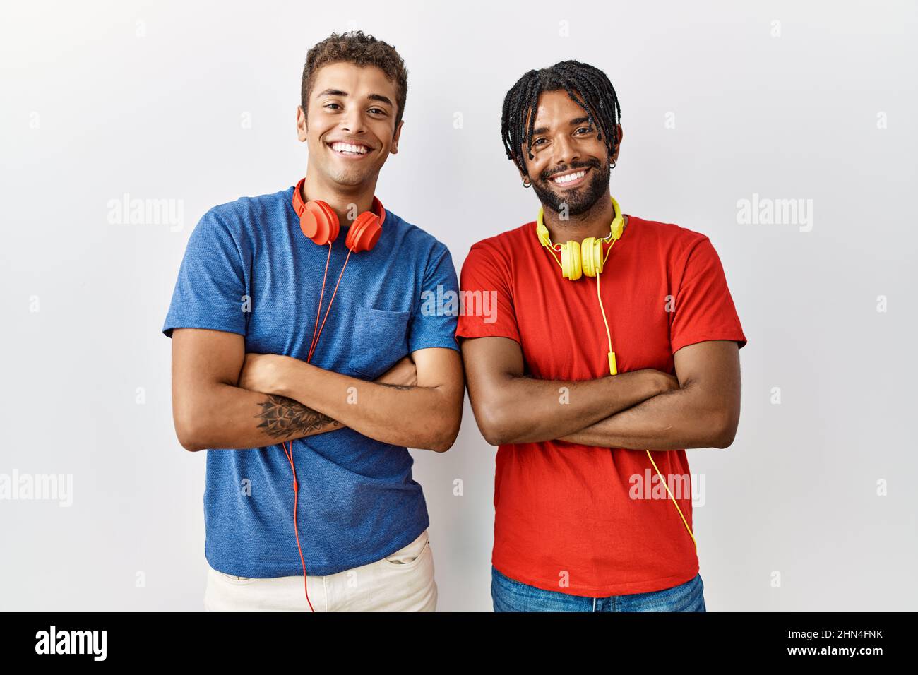 Young hispanic brothers standing over isolated background wearing ...