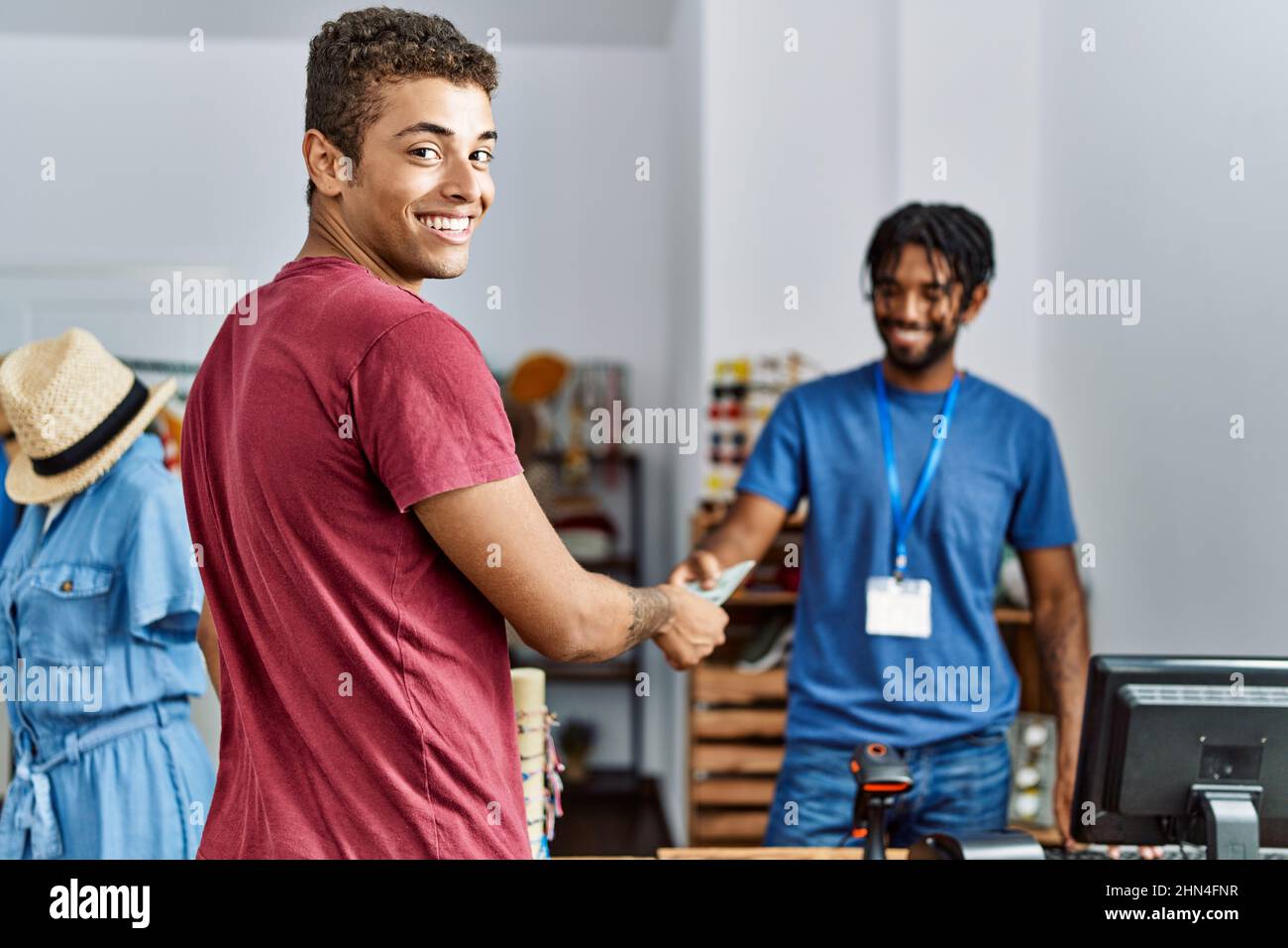 Two men shopkeeper and customer paying purchase with dollars at ...