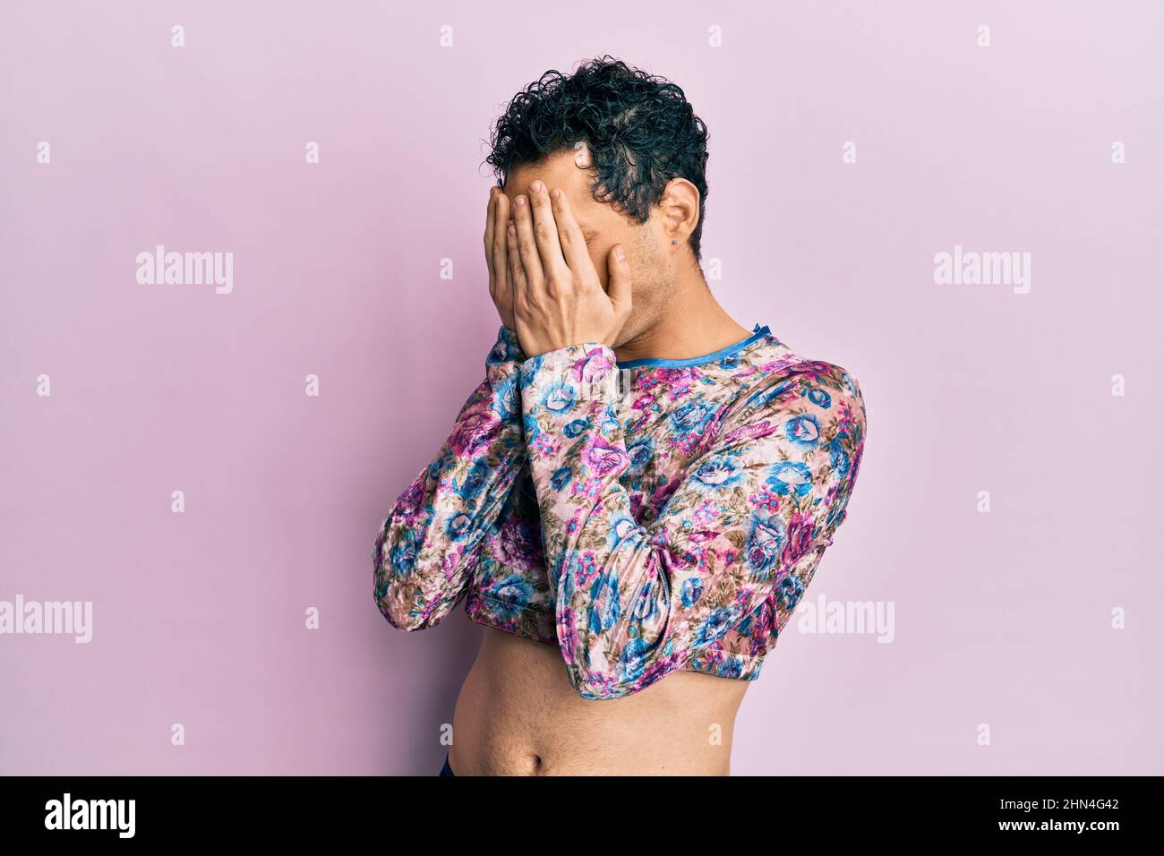 Handsome man wearing make up wearing fashion clothes with sad ...
