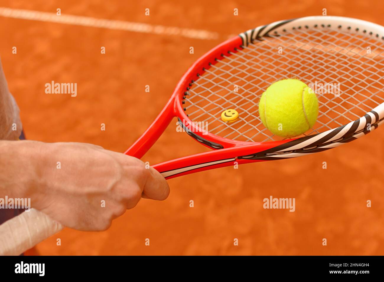 Male player holding tennis ball and racket on tennis court Stock Photo ...