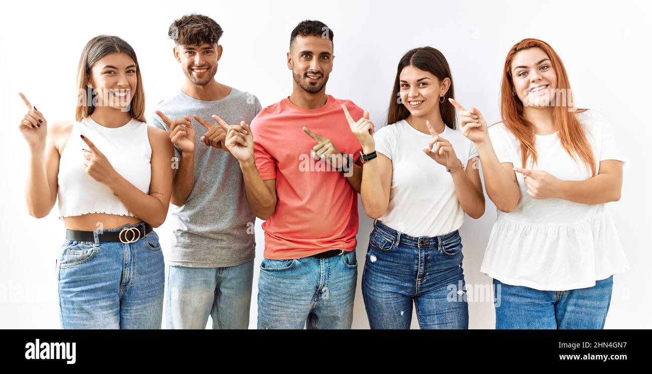 Group of young friends standing together over isolated background ...