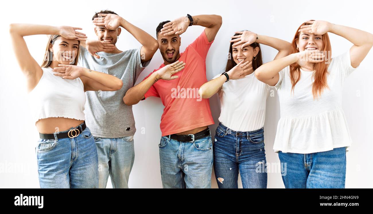 Group of young friends standing together over isolated background ...