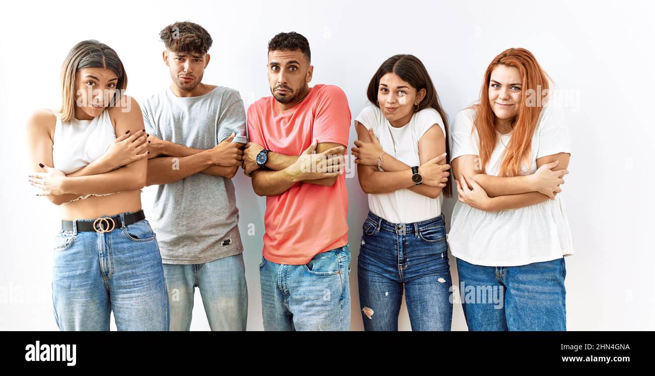 Group of young friends standing together over isolated background ...