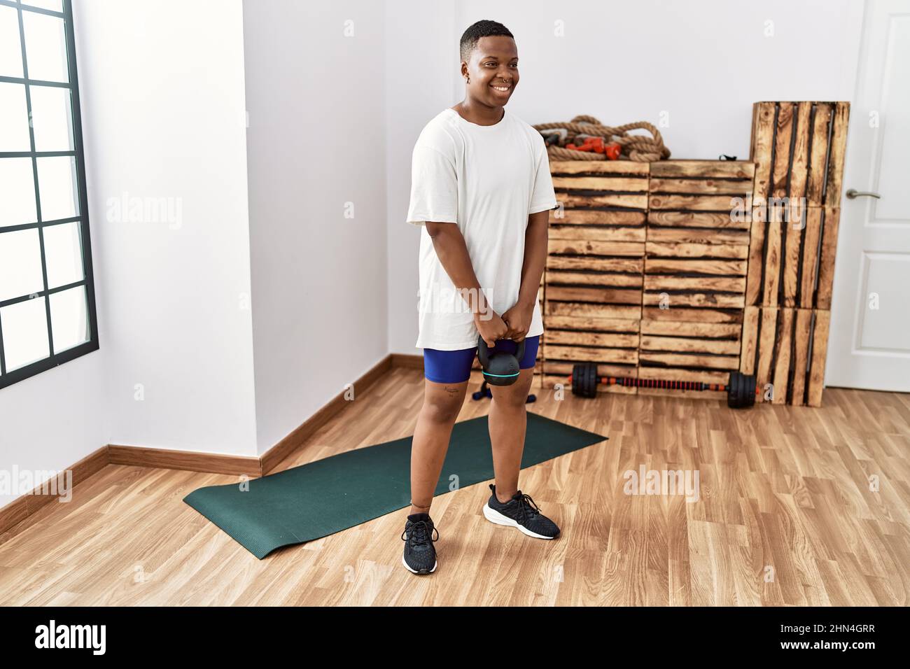 Young african man training with dumbbells at the gym Stock Photo - Alamy