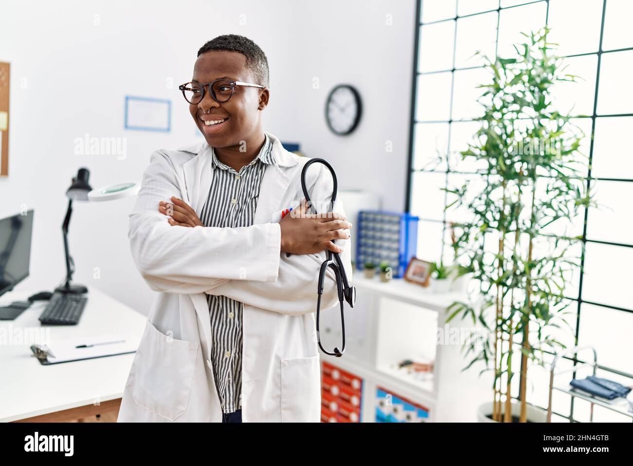 Young african man working as doctor holding stethoscope at medical ...