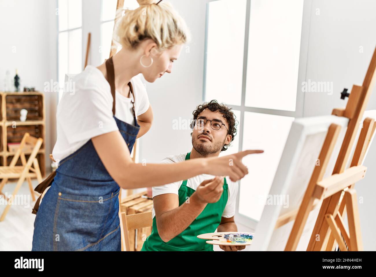 Paint teacher woman teaching to student man at art studio Stock Photo ...