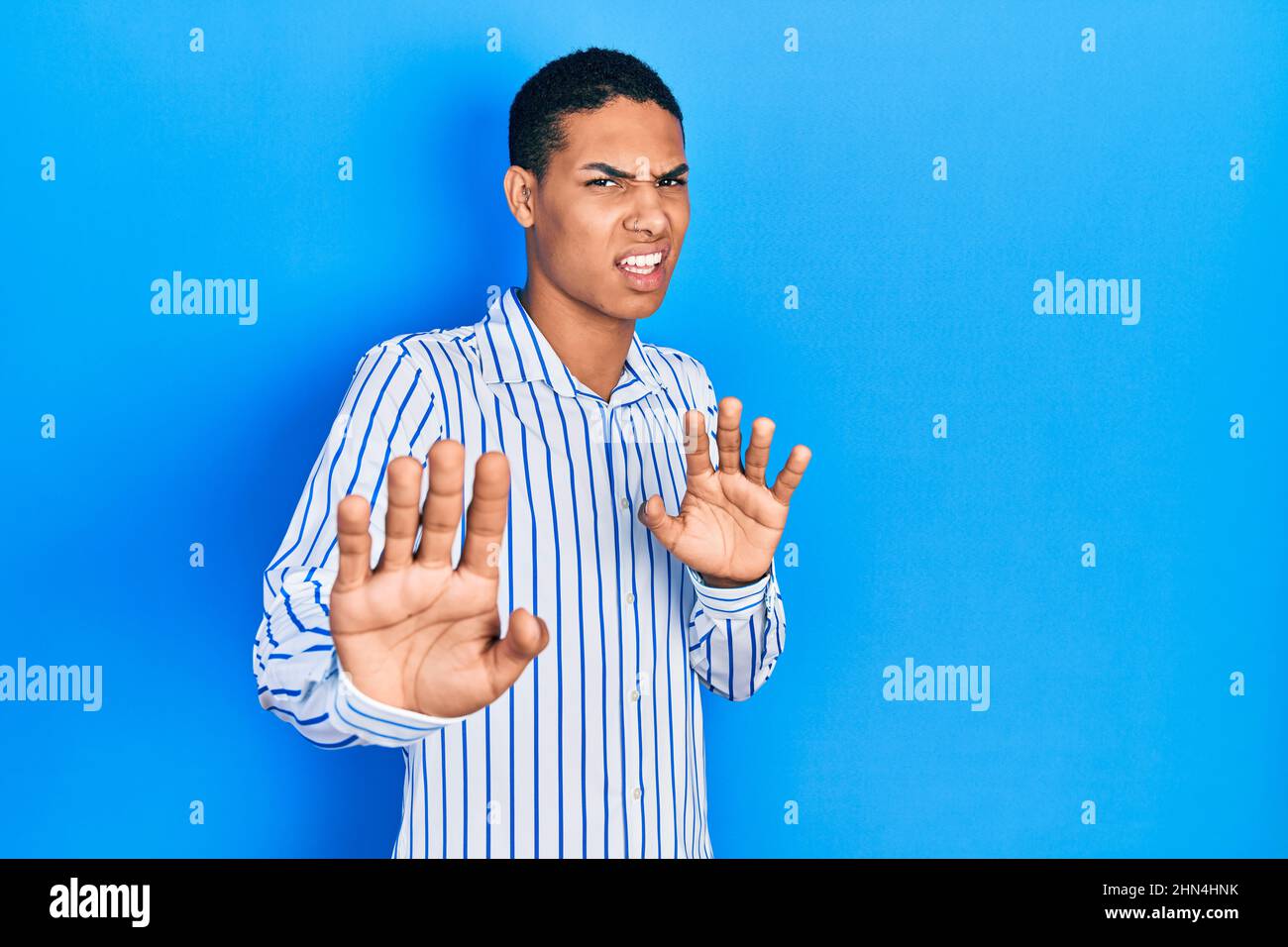 Young african american guy wearing casual clothes disgusted expression ...