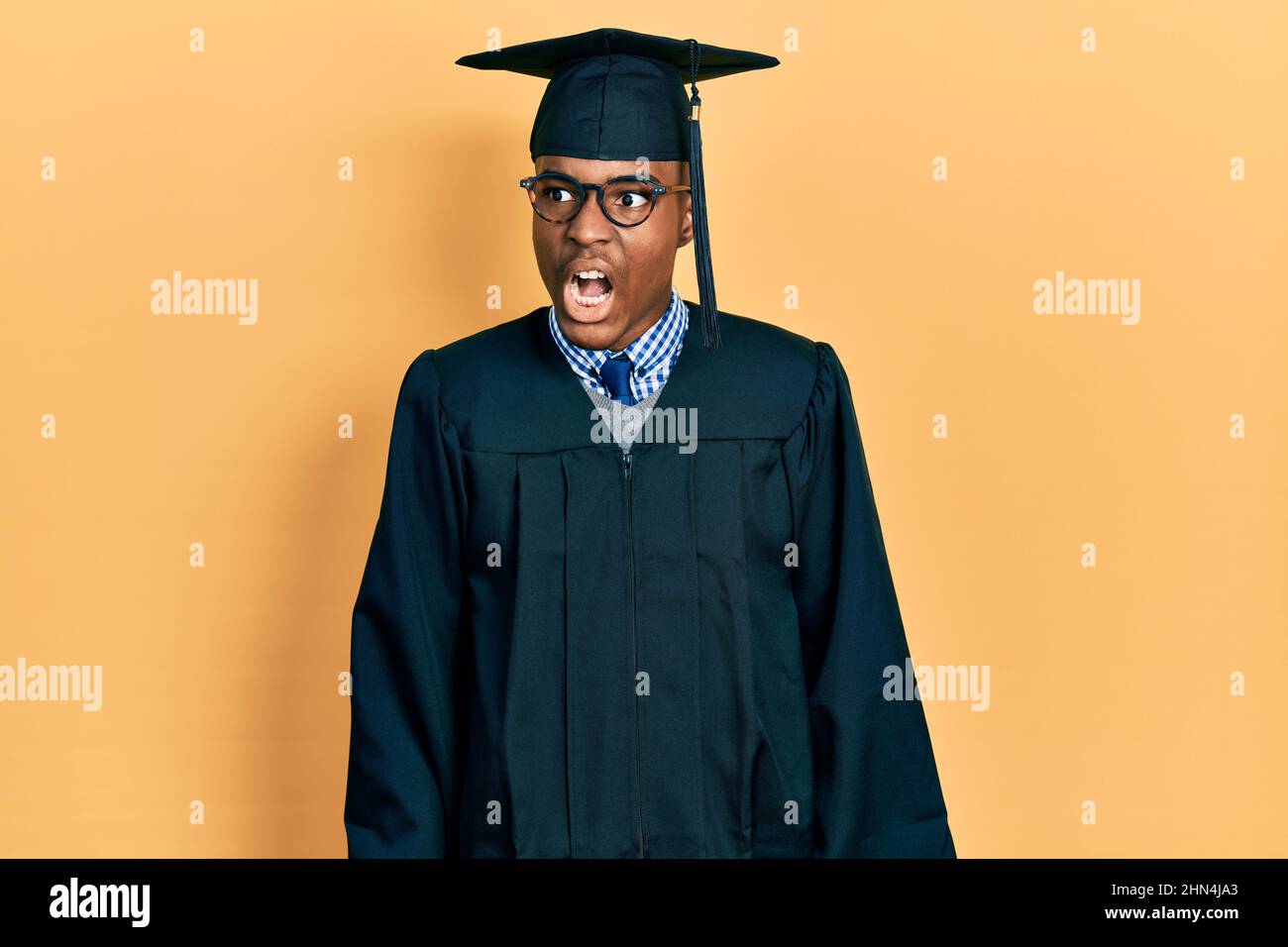 Young african american man wearing graduation cap and ceremony robe ...