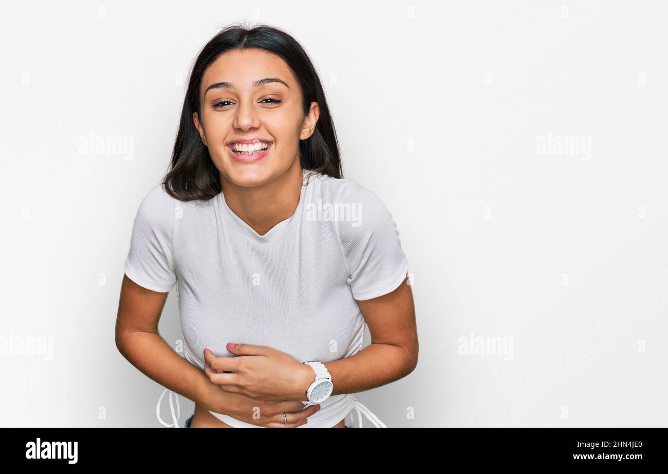 Young Hispanic Girl Wearing Casual White T Shirt Smiling And Laughing