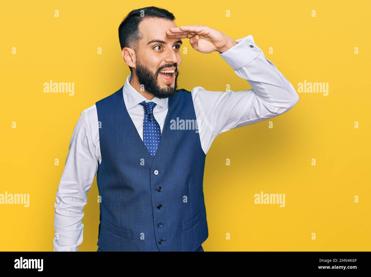 Young man with beard wearing business vest very happy and smiling ...