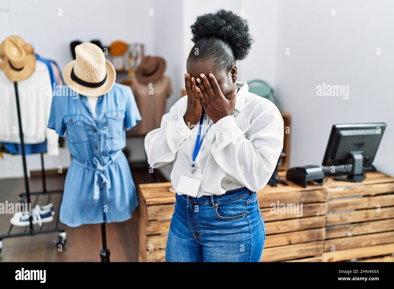 Young african woman working as manager at retail boutique with sad ...