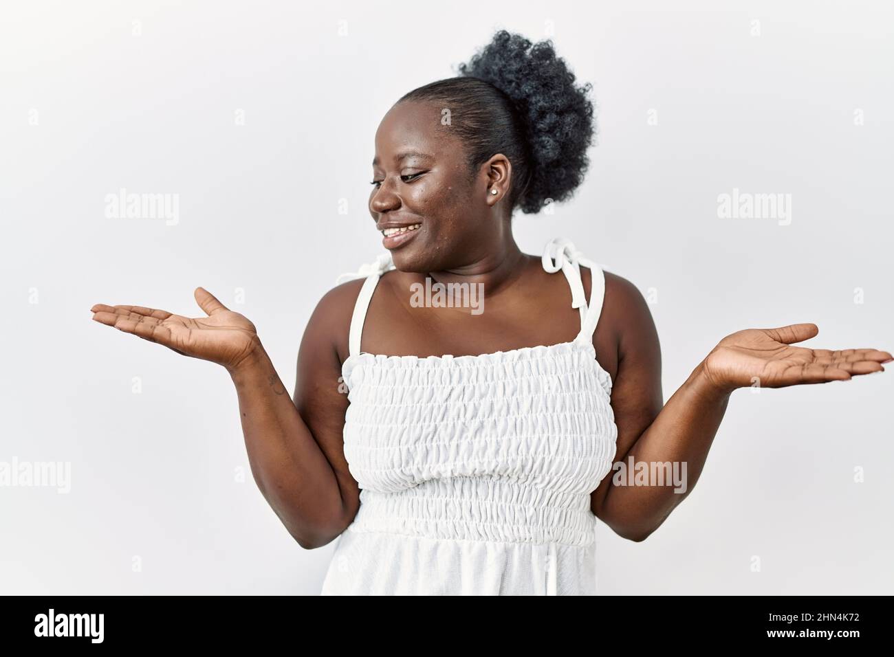 Young african woman standing over white isolated background smiling ...