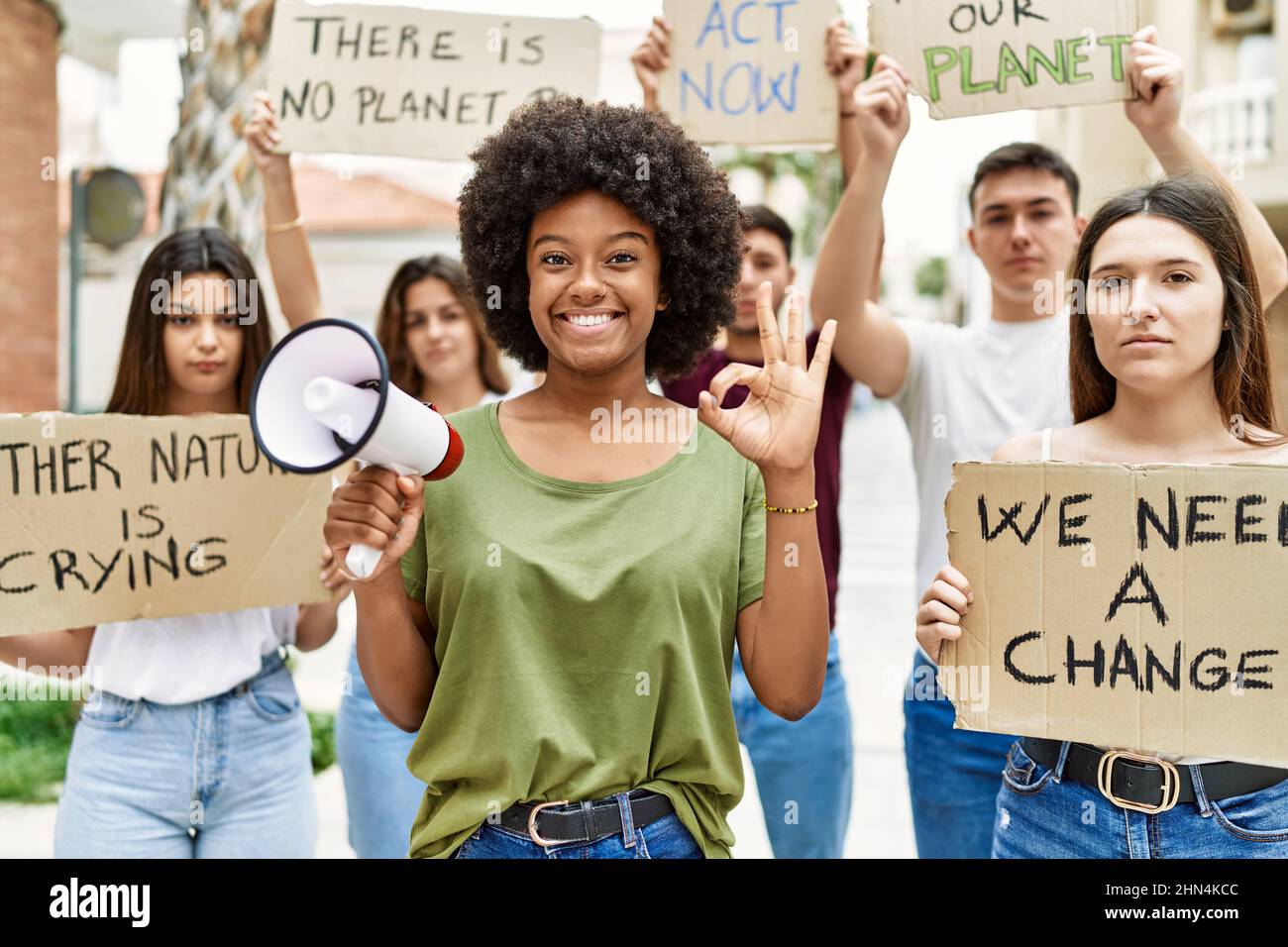 Group of young friends protesting and giving slogans at the street ...