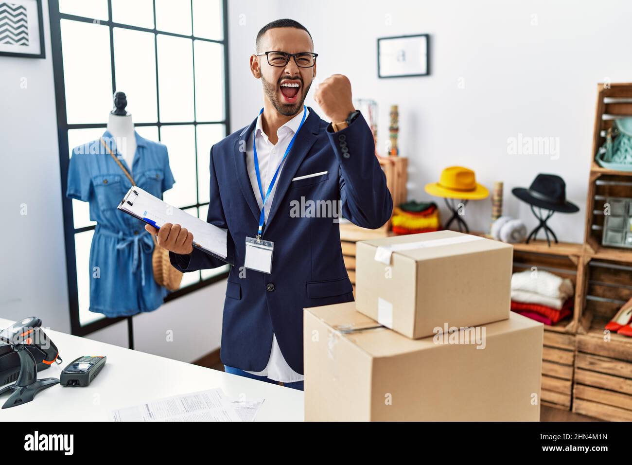 African american man working as manager at retail boutique angry and ...