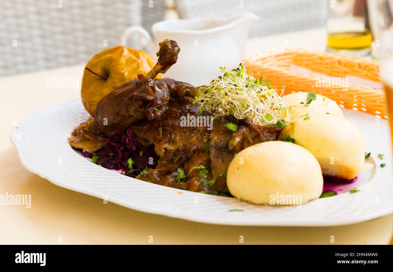 Baked duck with blue cabbage and yeast dumplings Stock Photo - Alamy