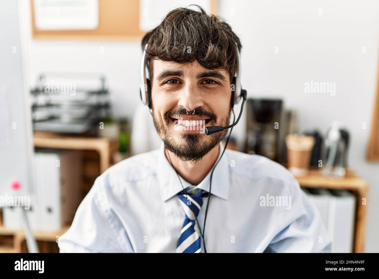 Young hispanic call center agent man smiling happy working at the ...