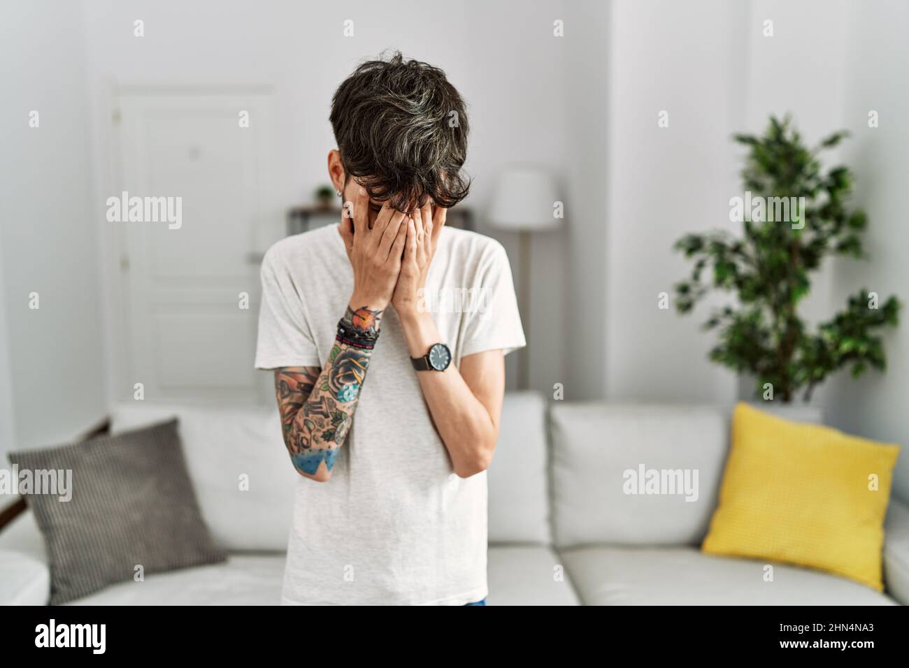 Hispanic man with beard at the living room at home with sad expression ...